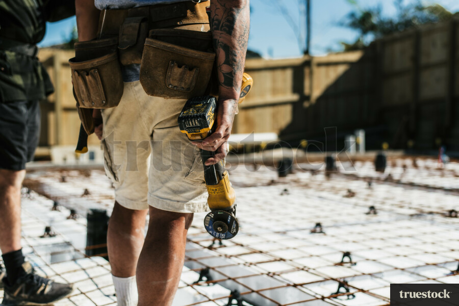 Tradies Working on Flooring by Helen Dol - Truestock