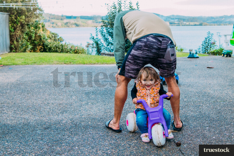 Kids Playing Outside with Dad by Kids & Co Photos - Laura Bolt - Truestock