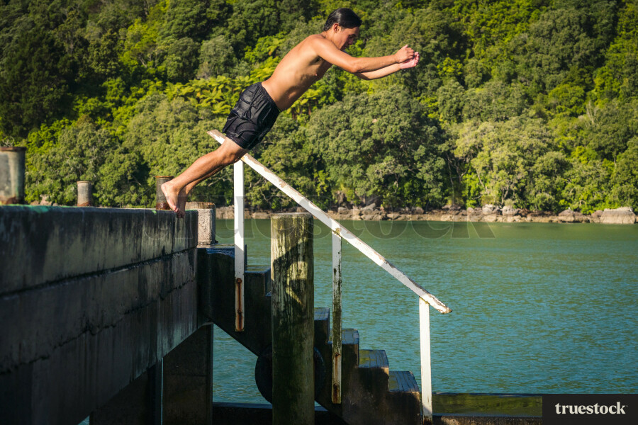 Jumping off the Wharf at Whangamata by Spid Pye - Truestock